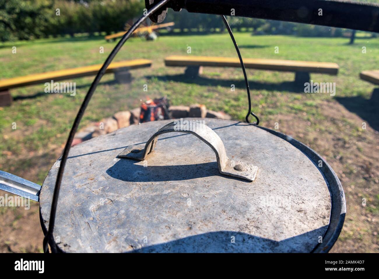 Cooking food in a big black kettle on fire outside Stock Photo - Alamy