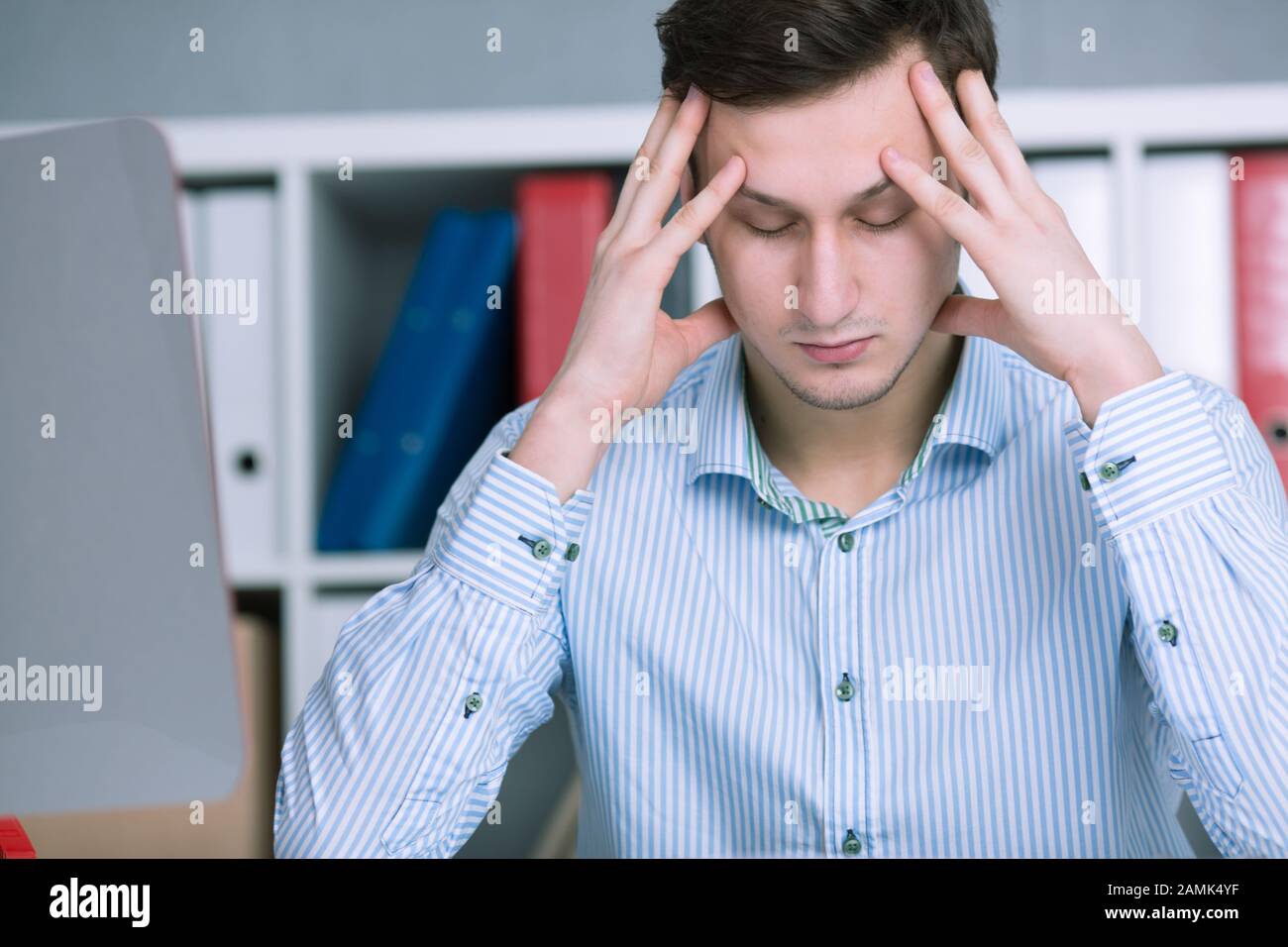 Businessman sitting in a stressful situation in the office. Hold your ...