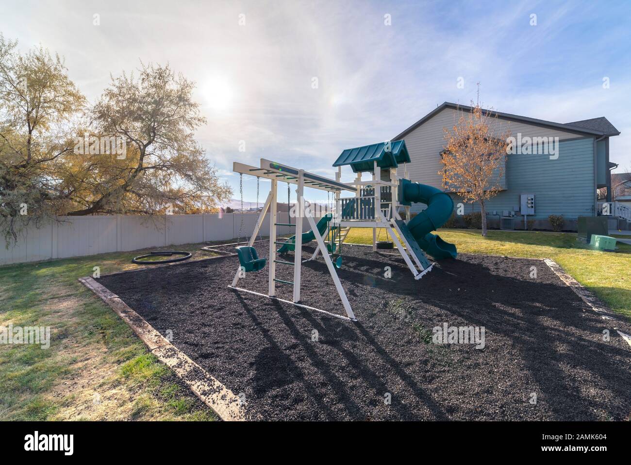 Swings and slides at a kids playground Stock Photo - Alamy