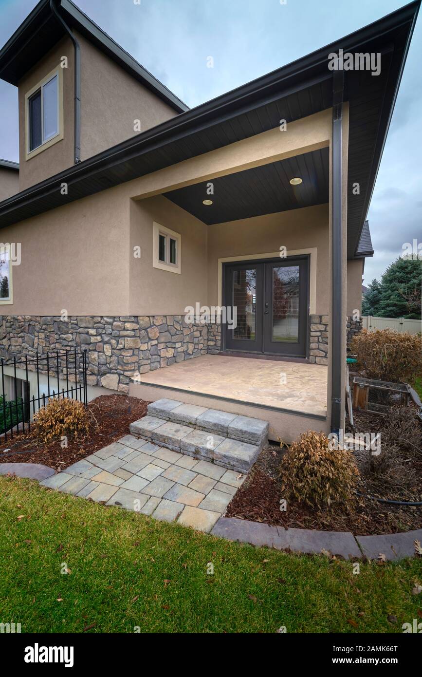 Paved steps to a tiled covered patio Stock Photo - Alamy