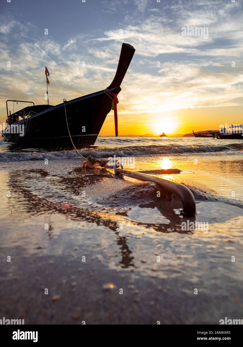 Traditional long-tail boat on the beach in Thailand Stock Photo - Alamy