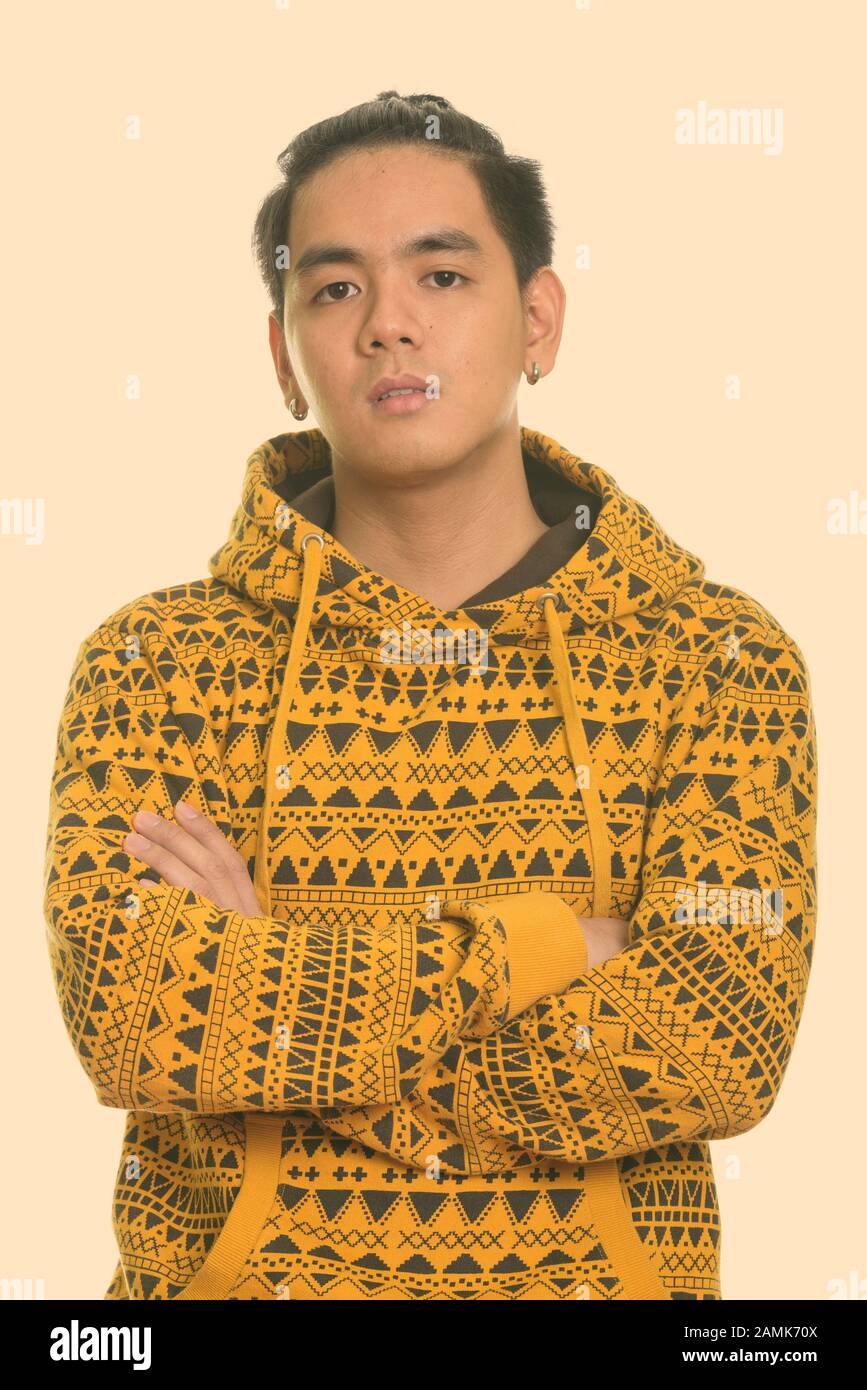 Studio shot of young handsome Filipino man isolated against white ...