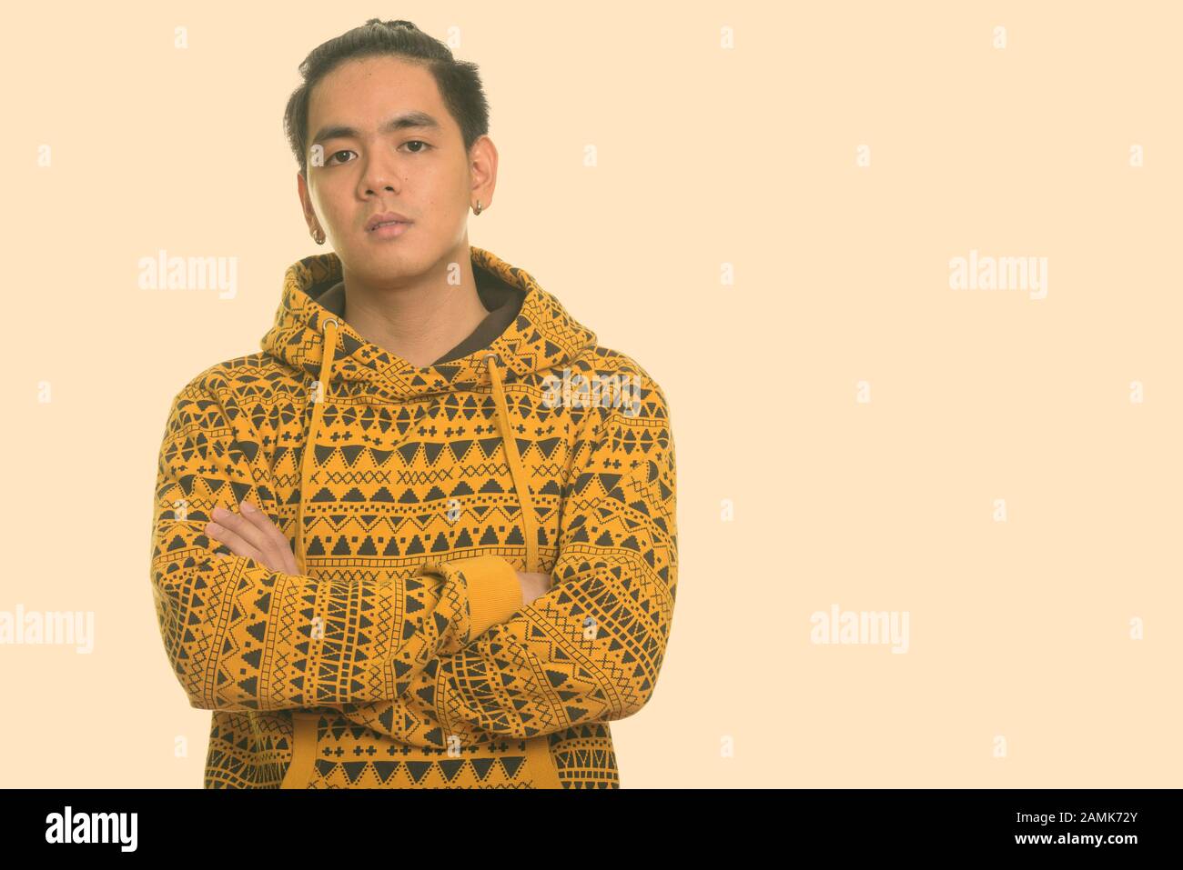 Studio shot of young handsome Filipino man isolated against white ...