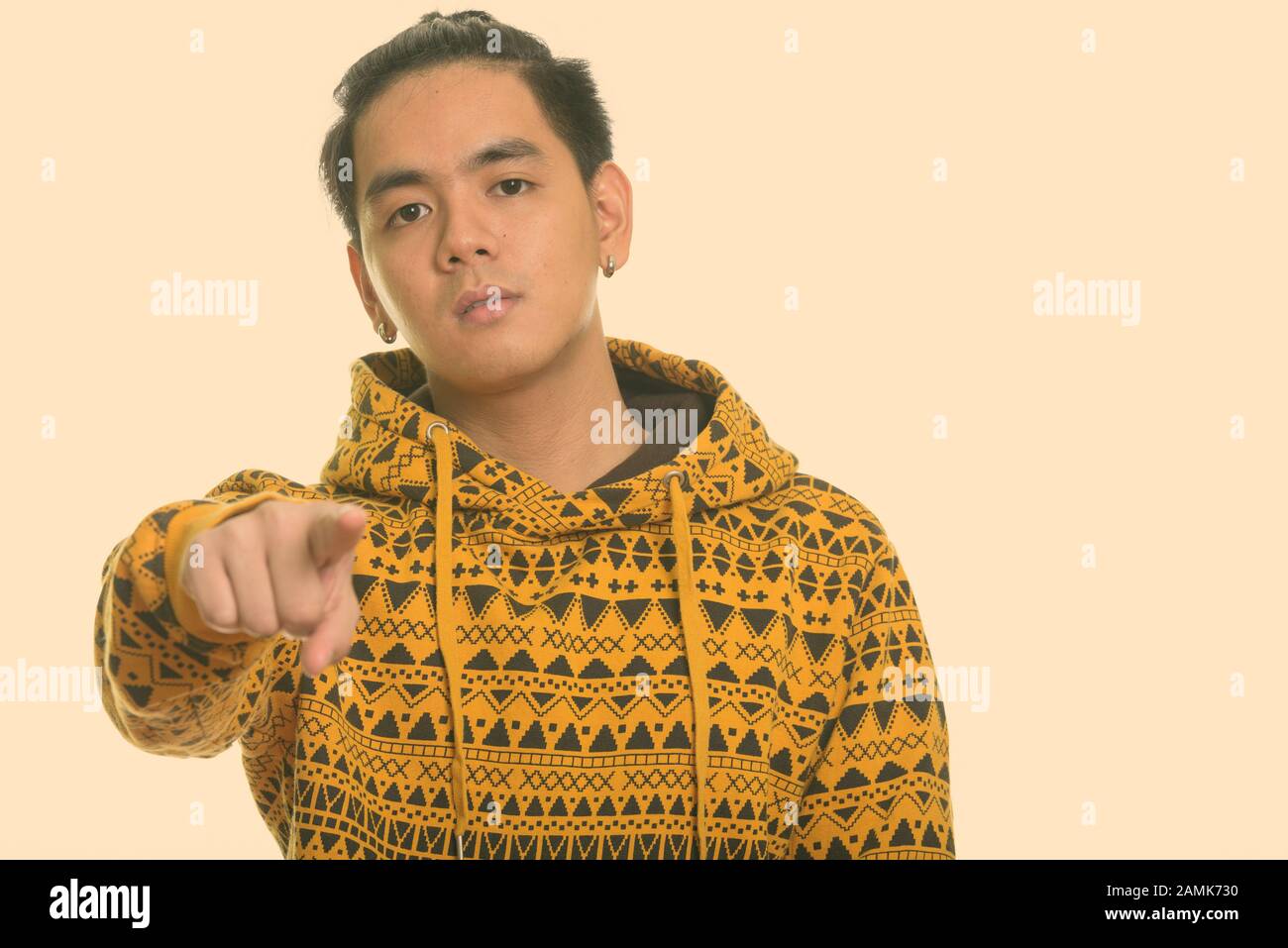 Studio shot of young handsome Filipino man isolated against white ...