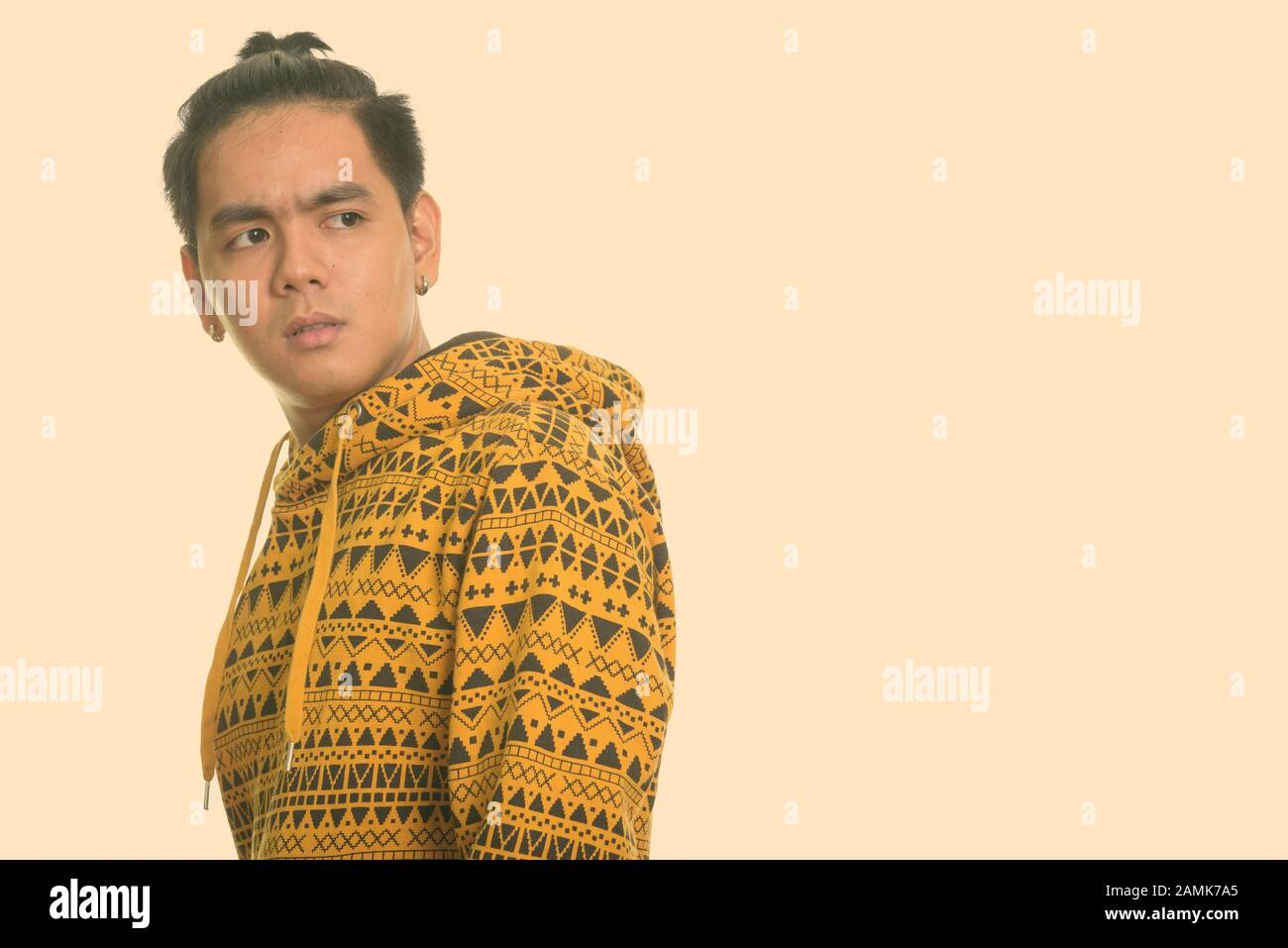 Studio shot of young handsome Filipino man isolated against white ...