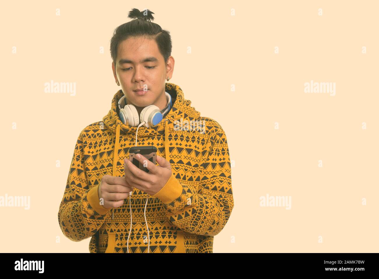 Studio shot of young handsome Filipino man isolated against white ...