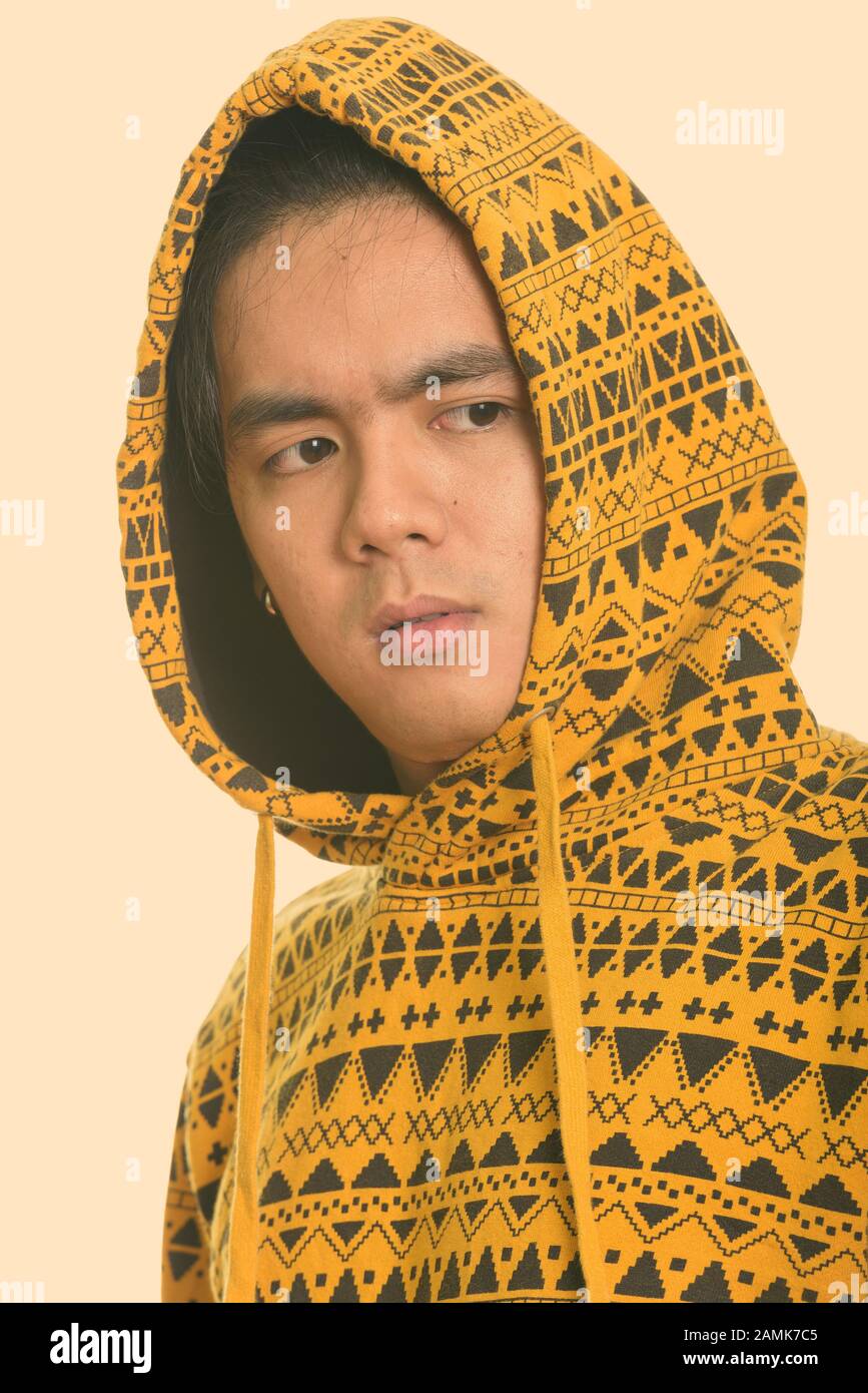 Studio shot of young handsome Filipino man isolated against white ...