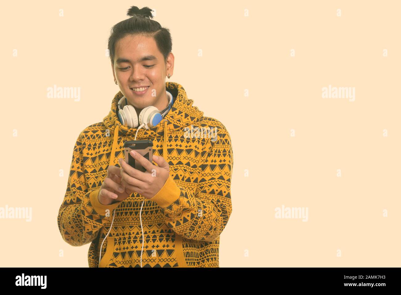 Studio shot of young handsome Filipino man isolated against white ...