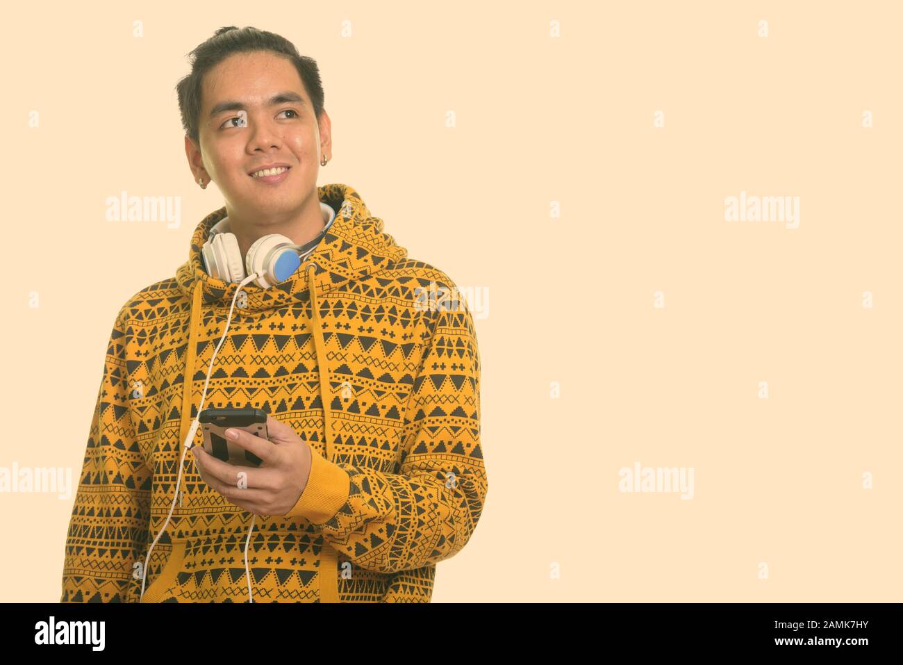 Studio shot of young handsome Filipino man isolated against white ...