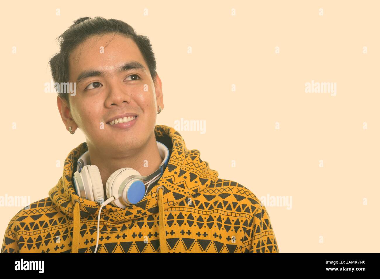 Studio shot of young handsome Filipino man isolated against white ...