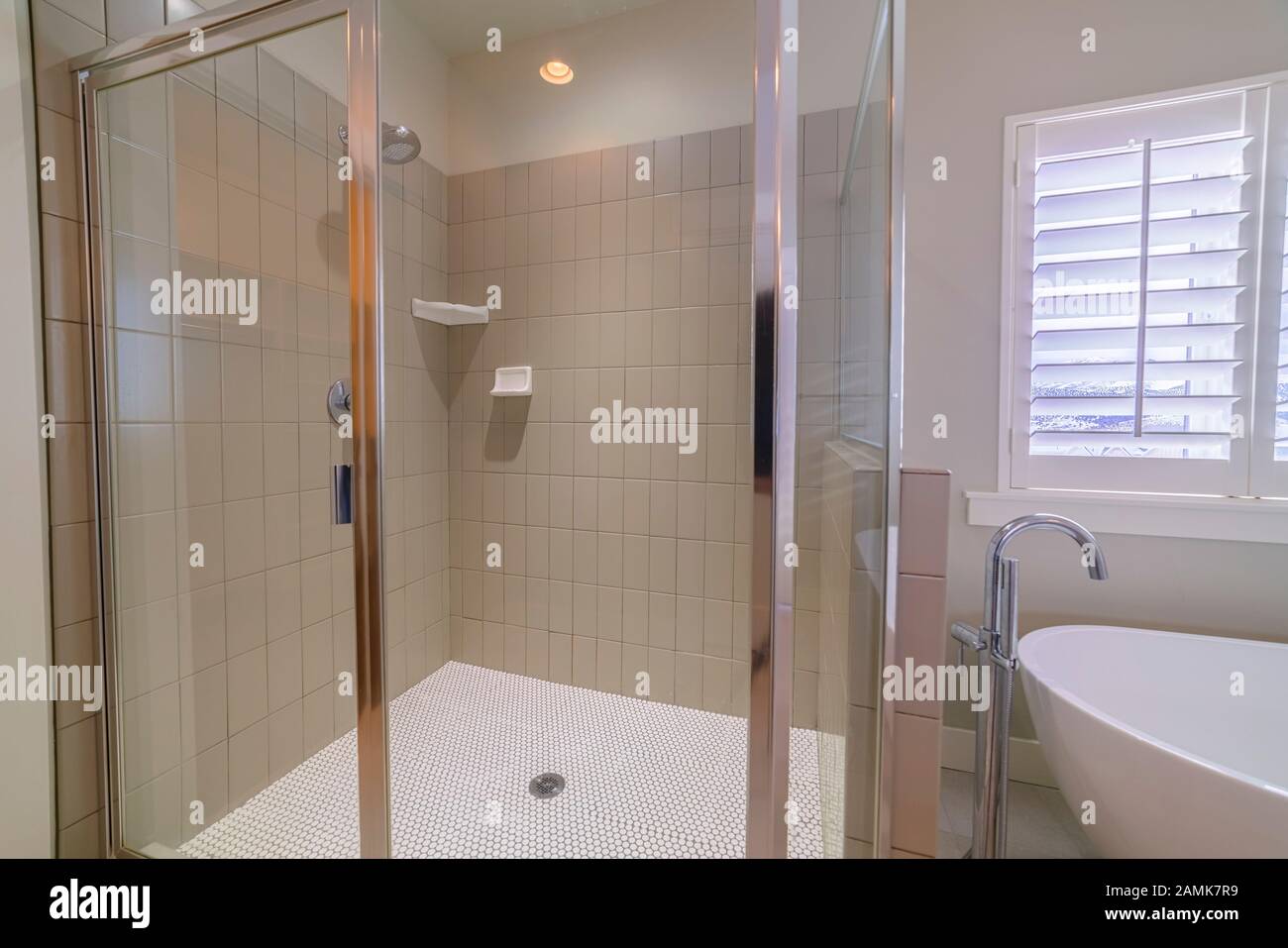 Modern tiled glass shower cubicle bright interior Stock Photo - Alamy