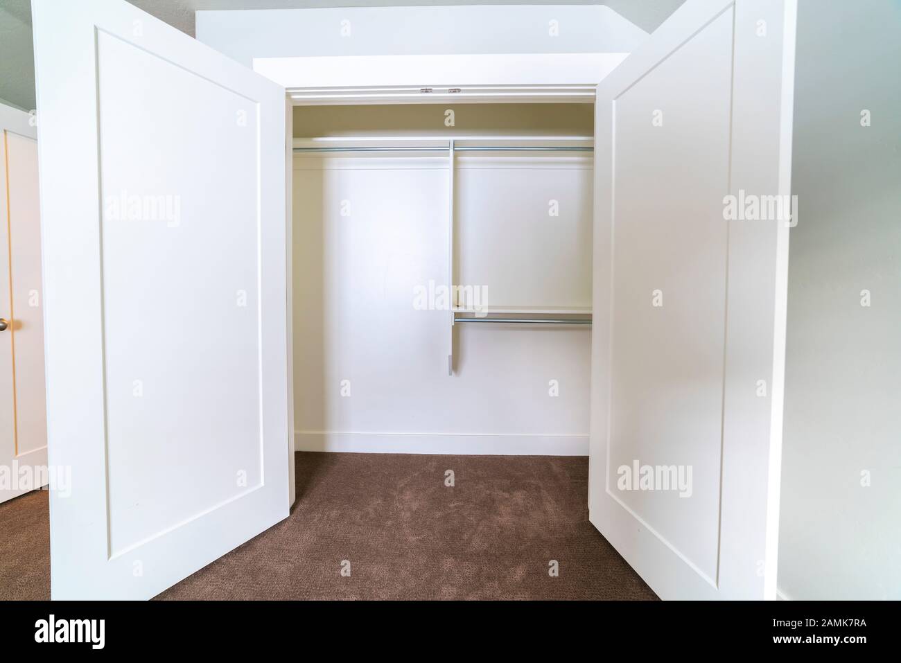 Empty interior of an open white closet Stock Photo - Alamy