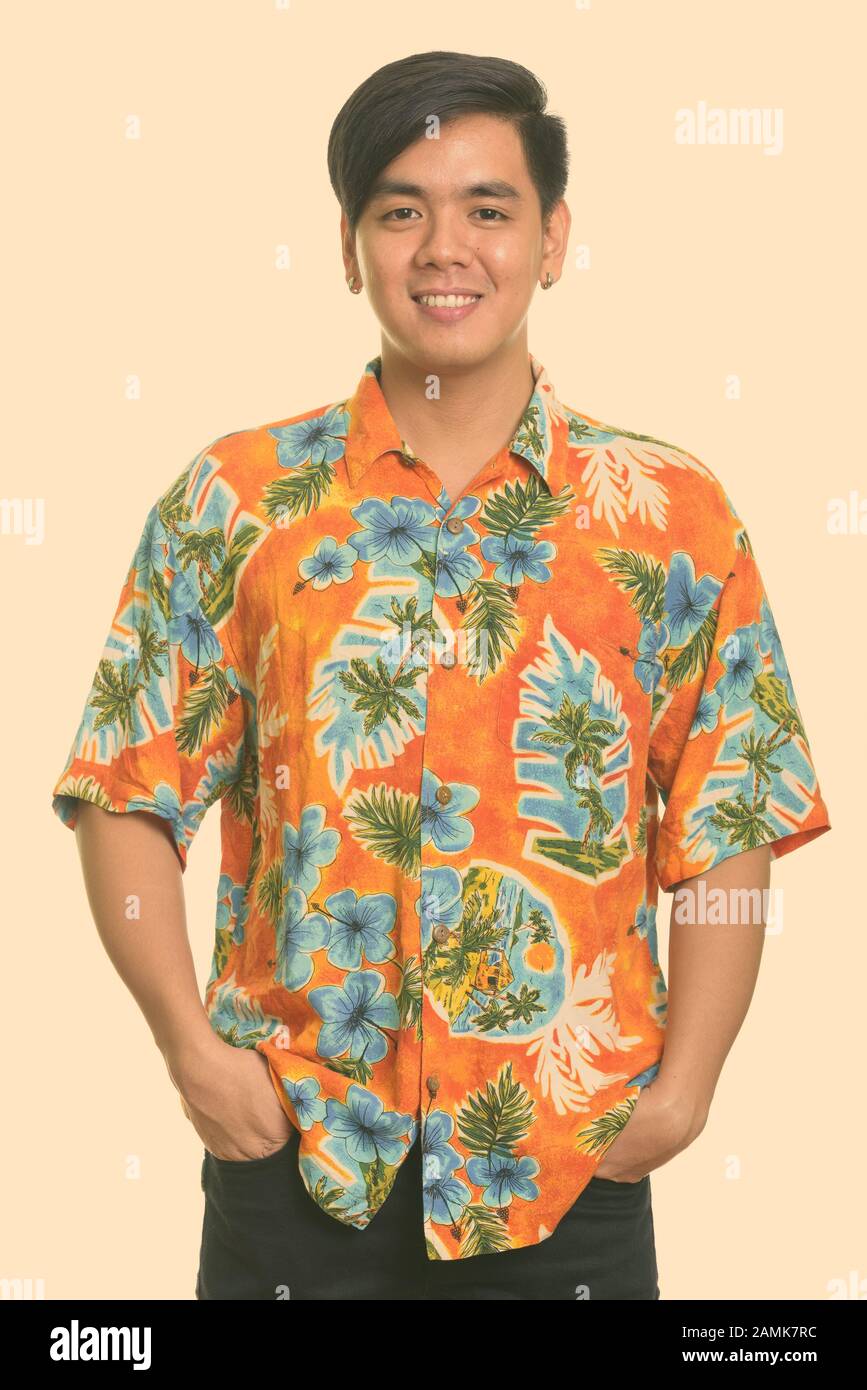 Studio shot of young handsome Filipino man isolated against white ...