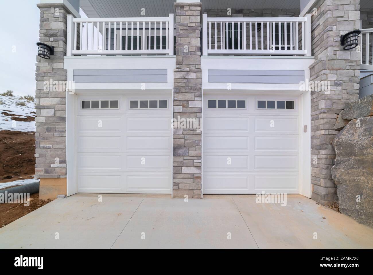 Two single garages sharing a cement driveway Stock Photo - Alamy
