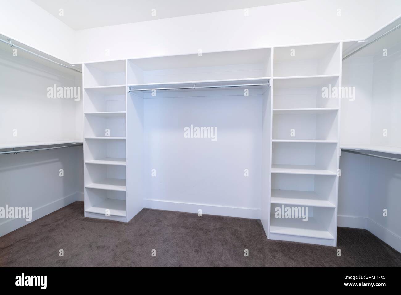 Empty fitted interior of a walk-in closet Stock Photo - Alamy