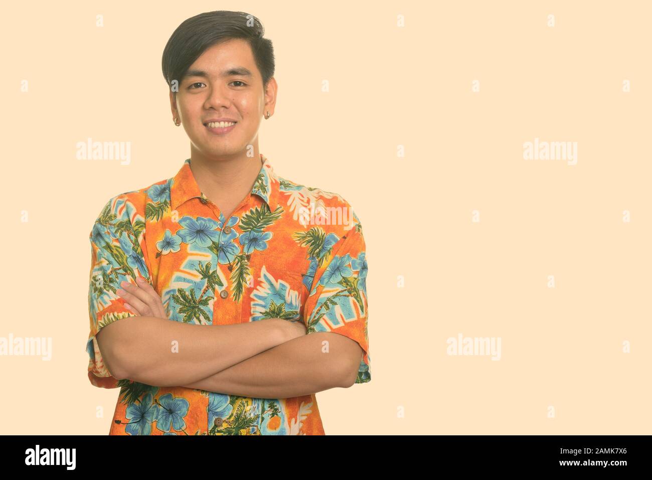 Studio shot of young handsome Filipino man isolated against white ...