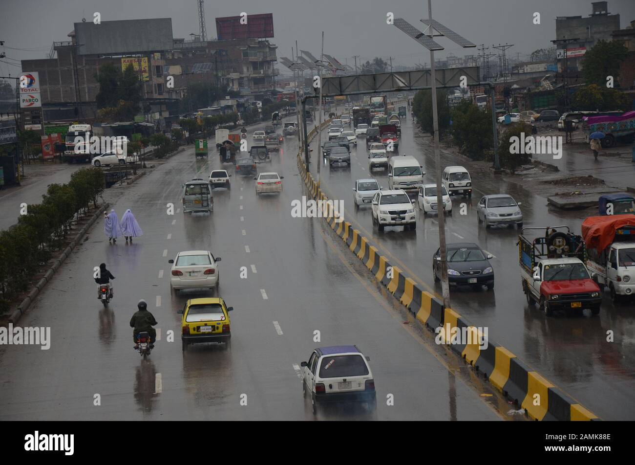 Peshawar, Pakistan. 13th Jan, 2020. A motorcyclist covers with a shawl ...