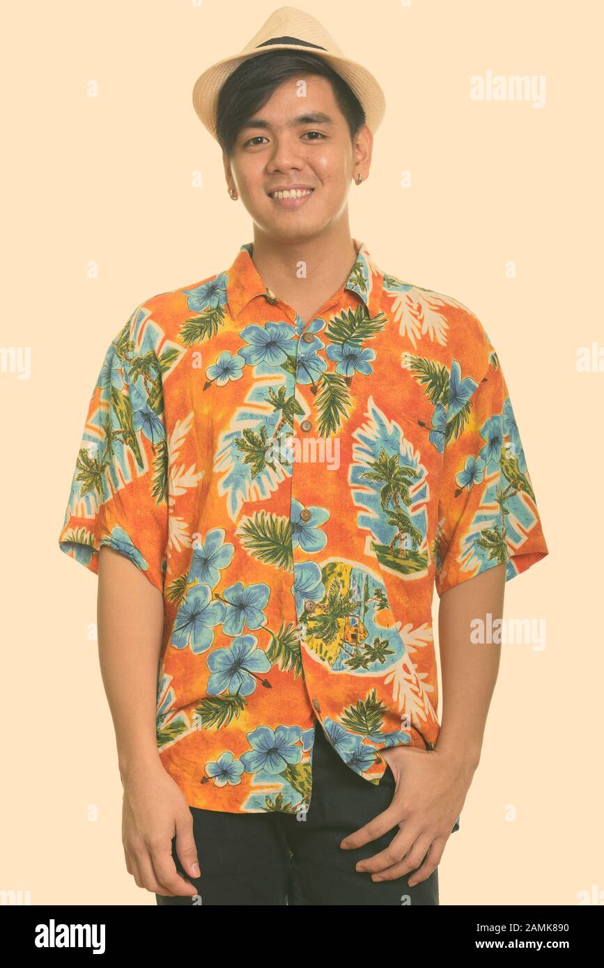 Studio shot of young handsome Filipino man isolated against white ...