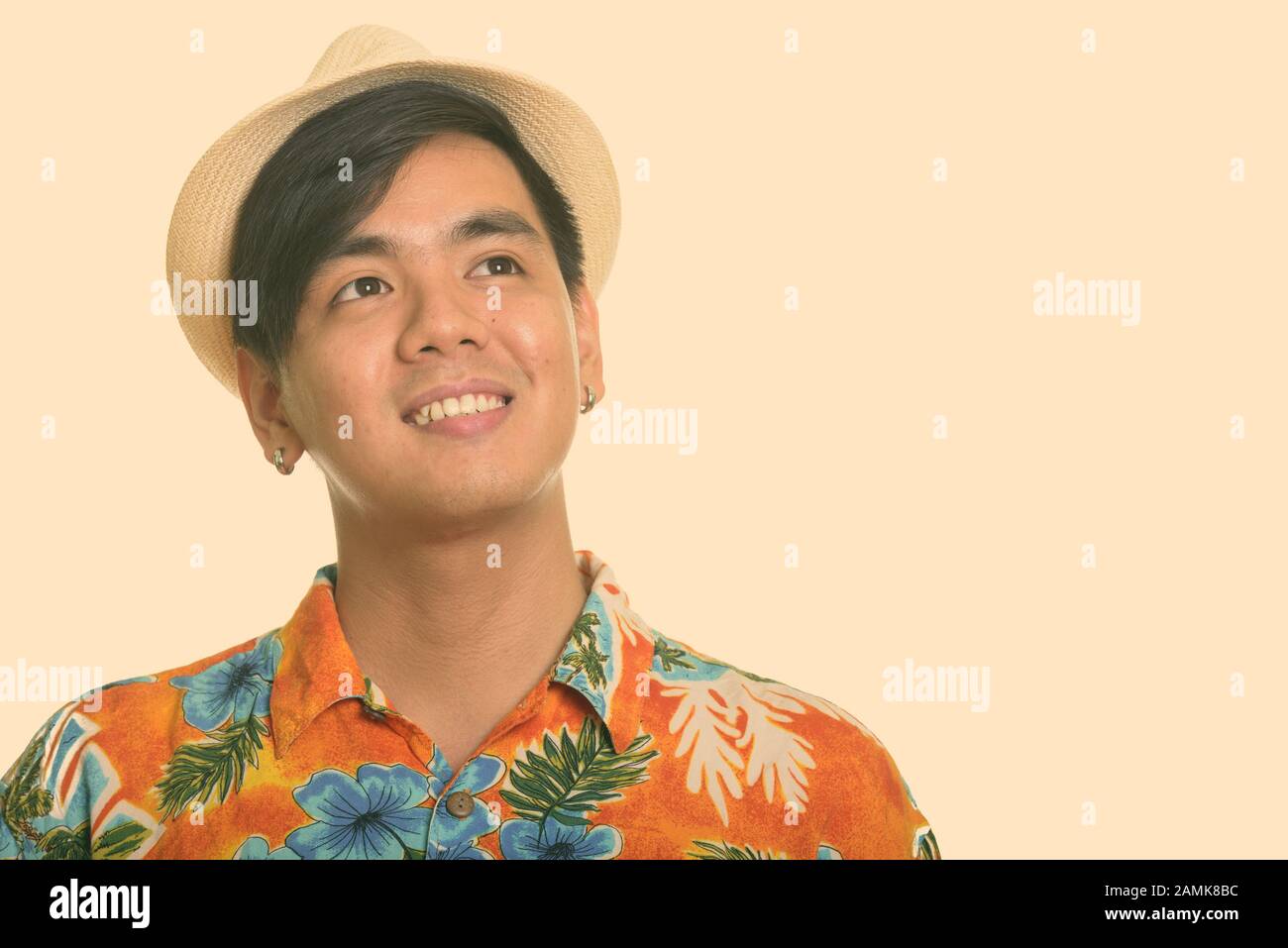 Studio shot of young handsome Filipino man isolated against white ...