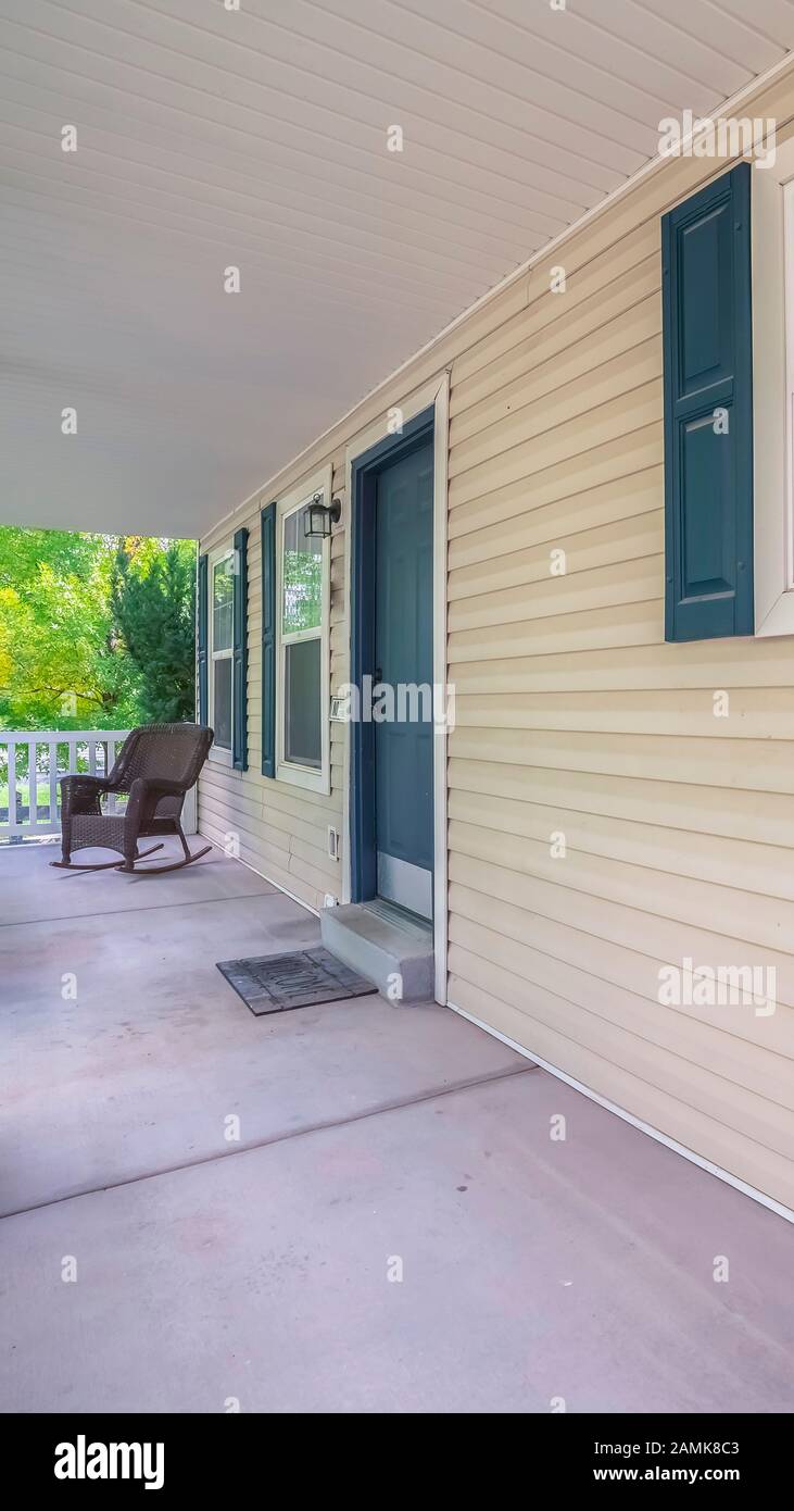 Vertical Long covered veranda in front of a timber house Stock Photo ...