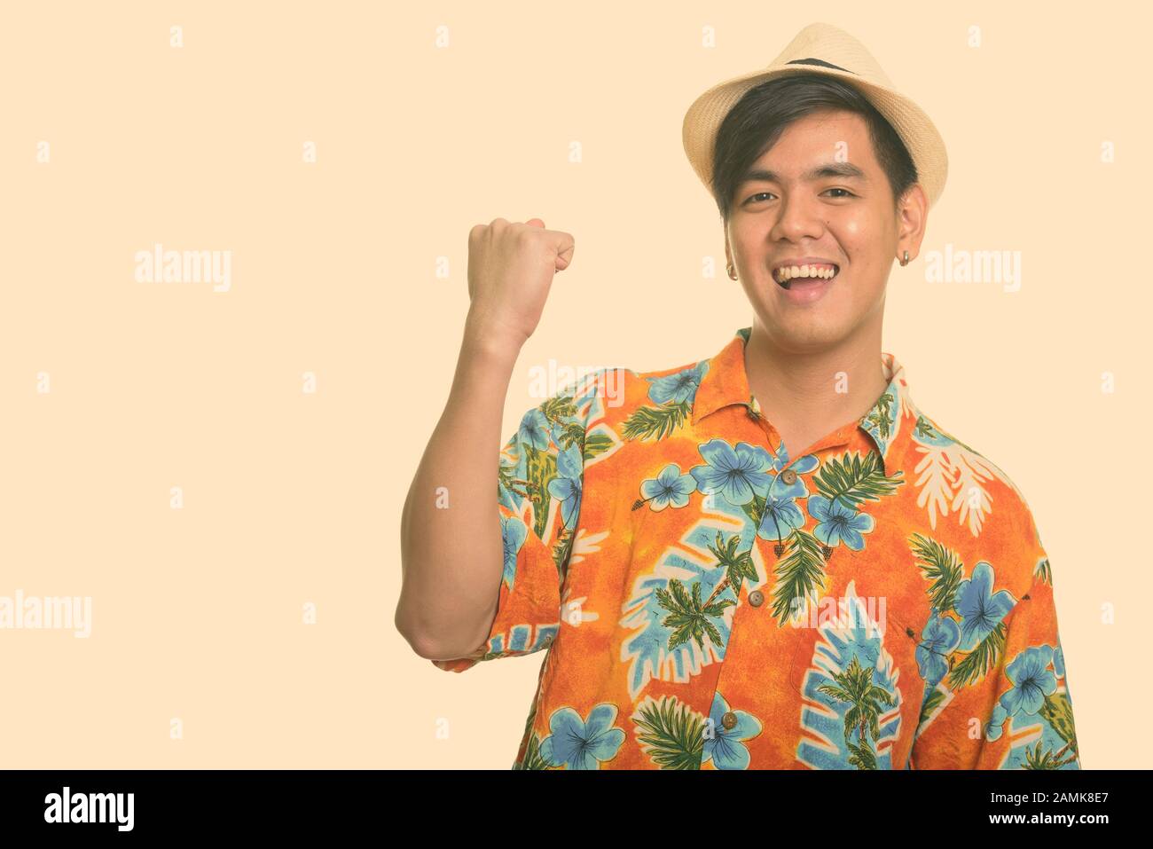 Studio shot of young handsome Filipino man isolated against white ...