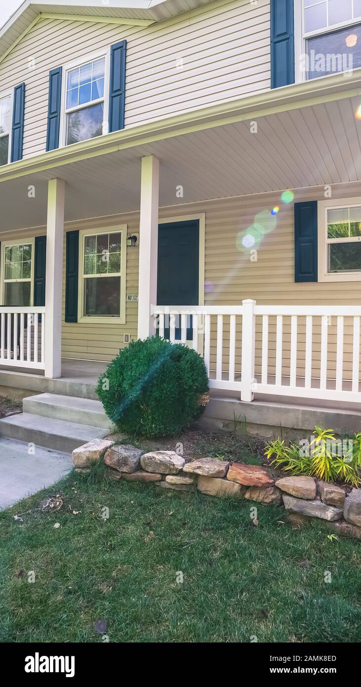 Vertical White timber house with shutters and veranda Stock Photo - Alamy