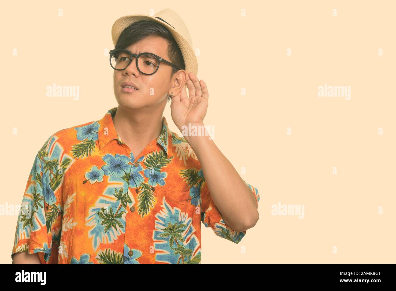 Studio shot of young handsome Filipino man isolated against white ...
