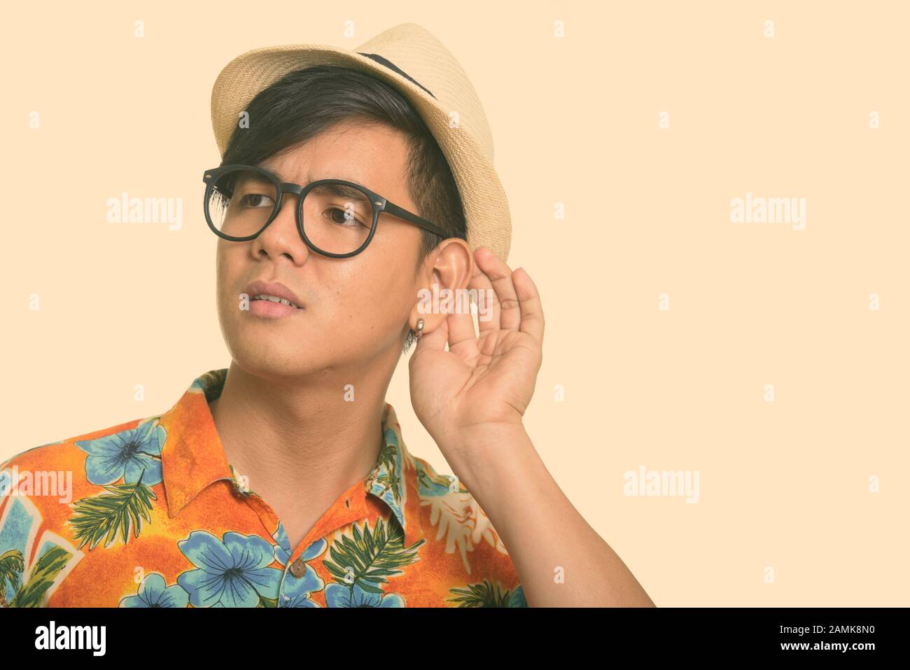 Studio shot of young handsome Filipino man isolated against white ...