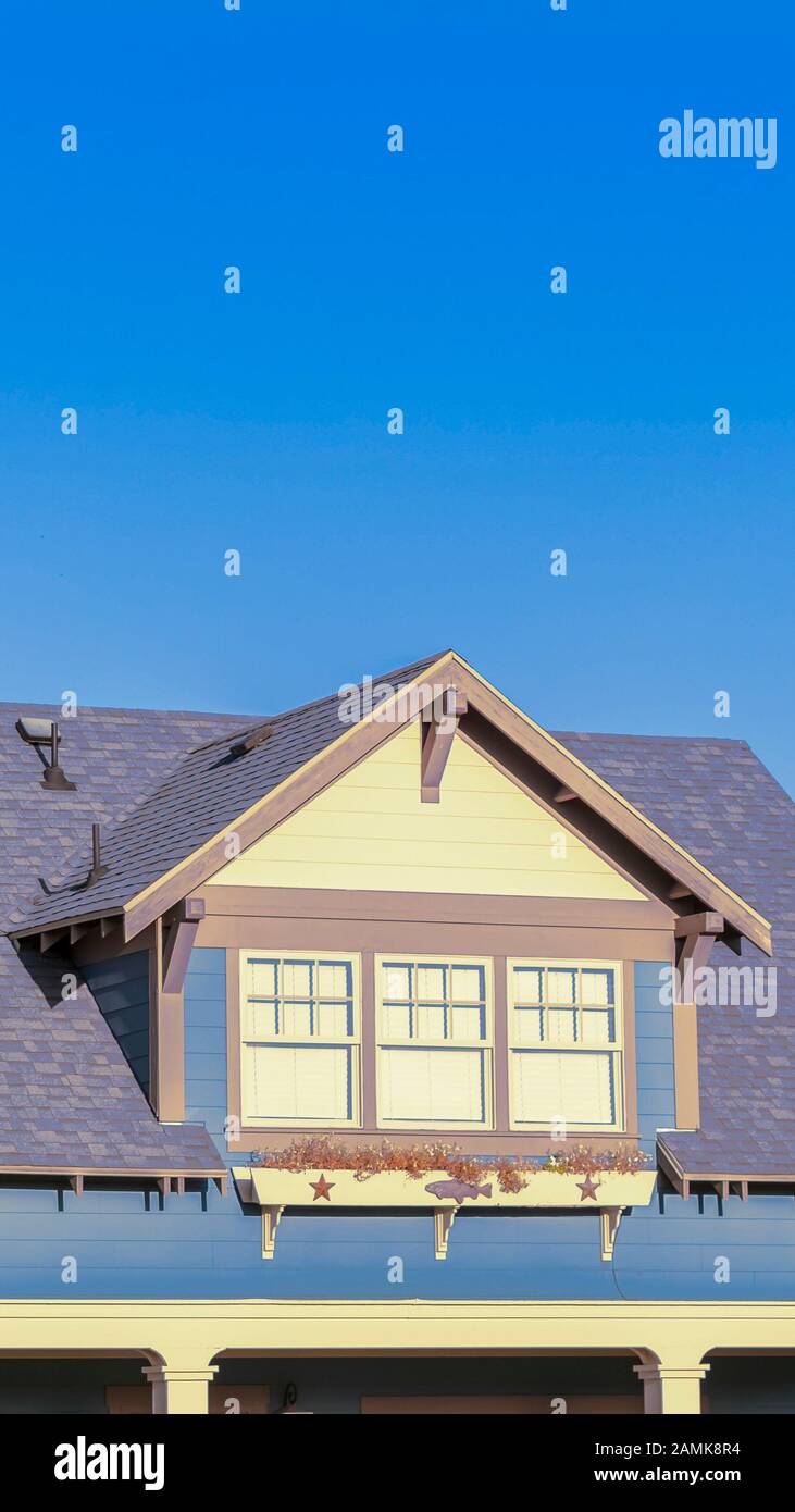 Vertical Large triple dormer window in an urban house Stock Photo - Alamy