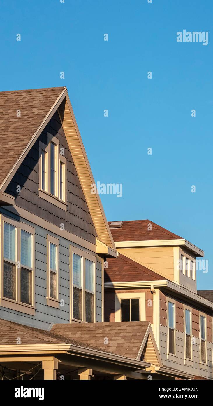 Vertical Upper facades of a row of timber clad houses Stock Photo - Alamy