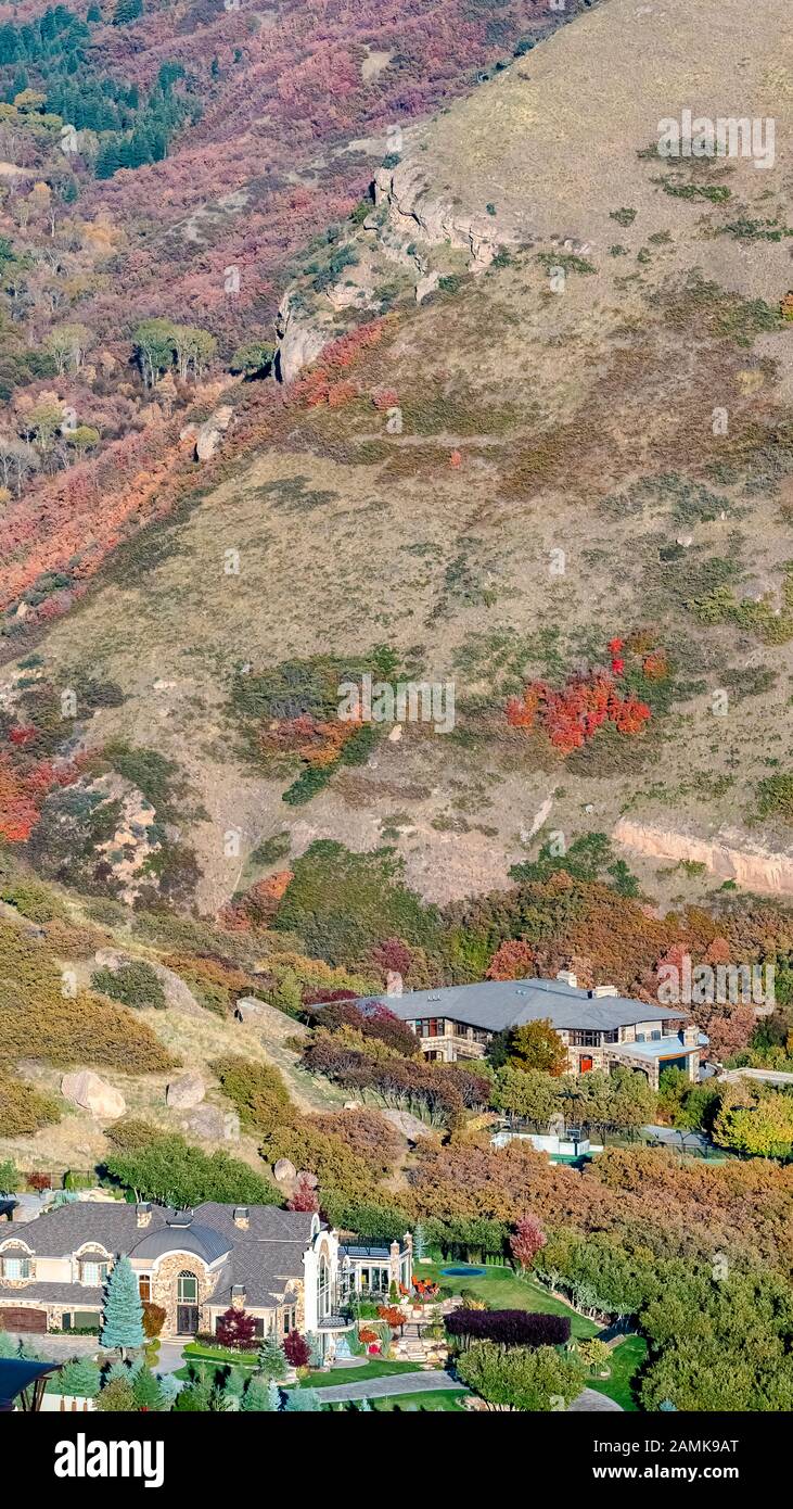 Vertical frame Large luxury home in a steep valley in fall Stock Photo ...