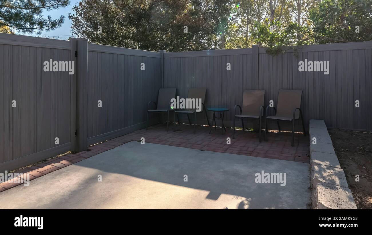 Panorama Small enclosed yard with high fence and gate Stock Photo - Alamy