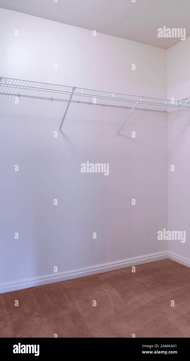 Vertical Empty white room with rails mounted to the walls Stock Photo ...