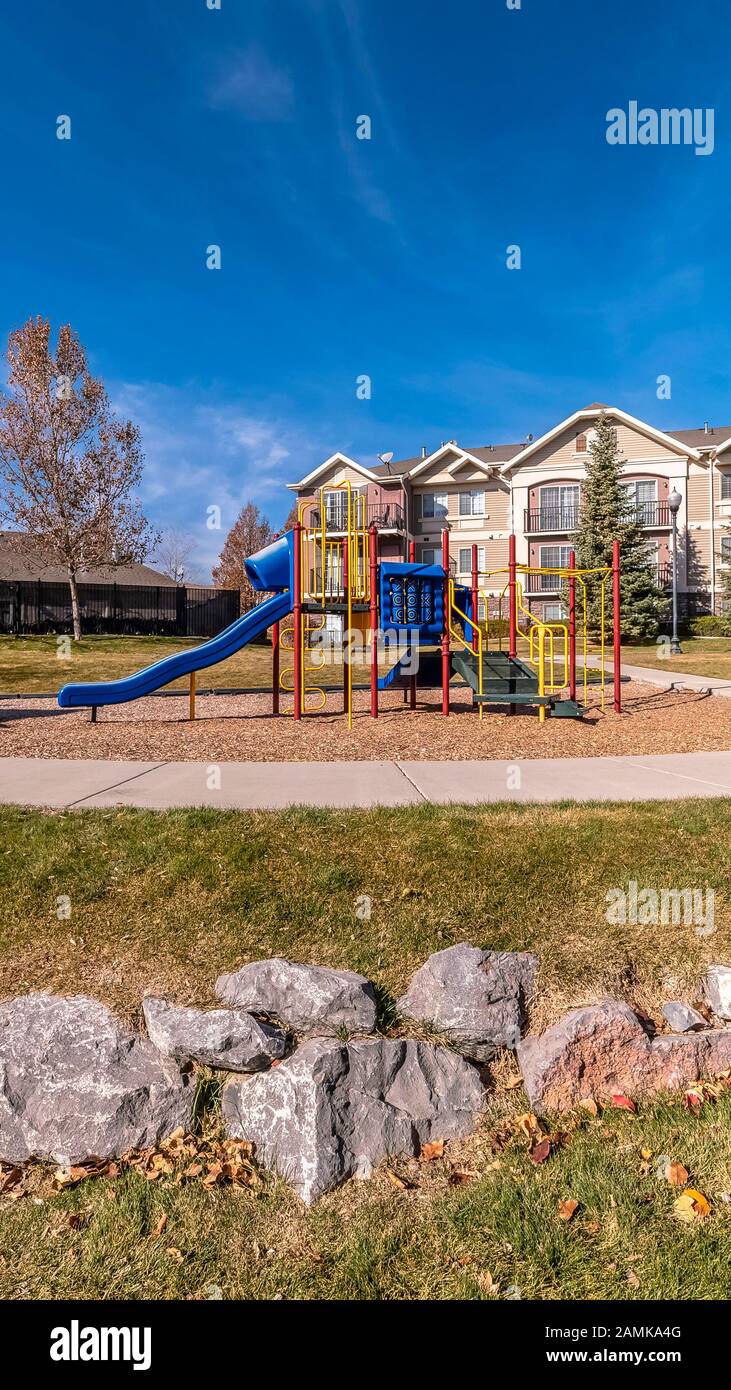 Vertical Kids playground in an urban park day light Stock Photo - Alamy