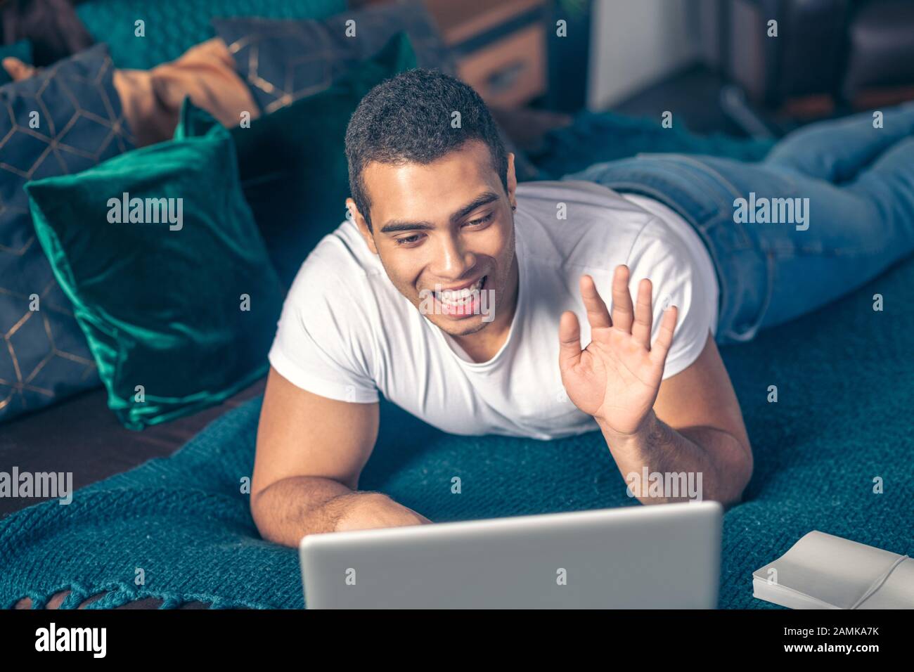 Smiling guy lying on bed hi-res stock photography and images - Alamy