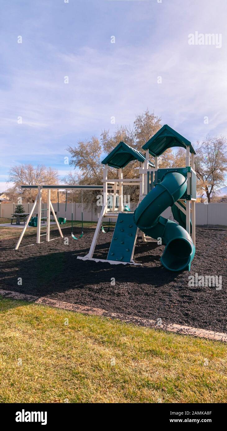 Vertical Kids playground in a walled park or estate Stock Photo - Alamy