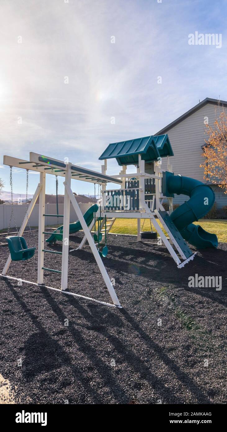 Vertical Swings and slides at a kids playground Stock Photo - Alamy