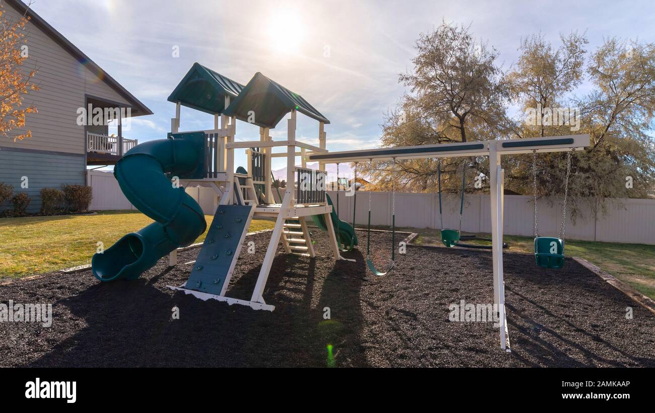 Panorama frame Small kids playground in a private garden Stock Photo ...