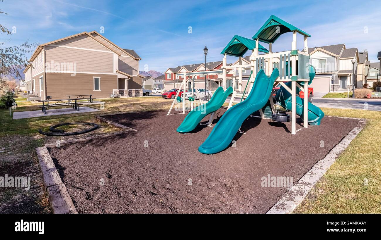 Panorama Colourful bright blue slides in a kids playground Stock Photo ...
