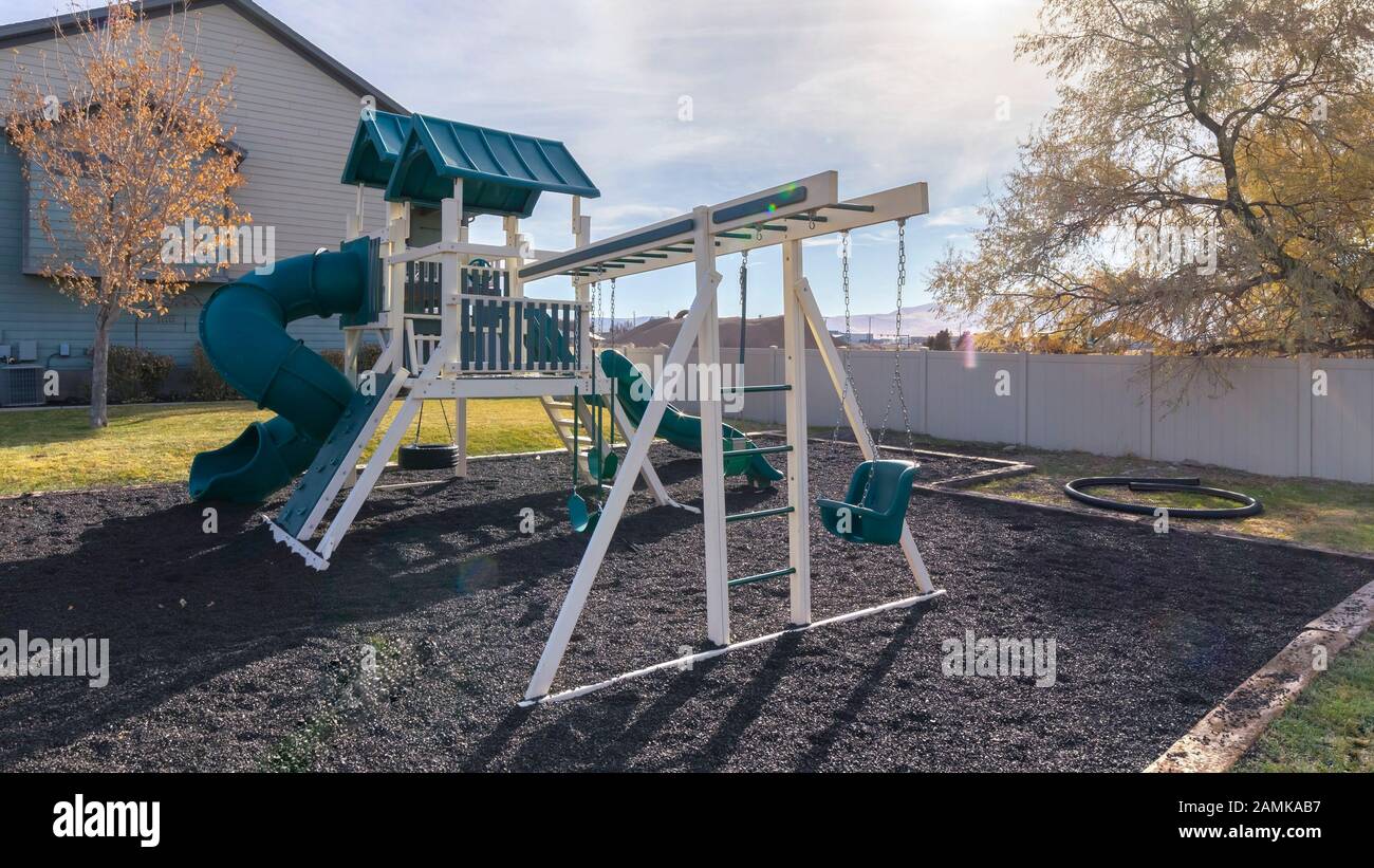 Panorama frame Swings and slides at a kids playground Stock Photo - Alamy