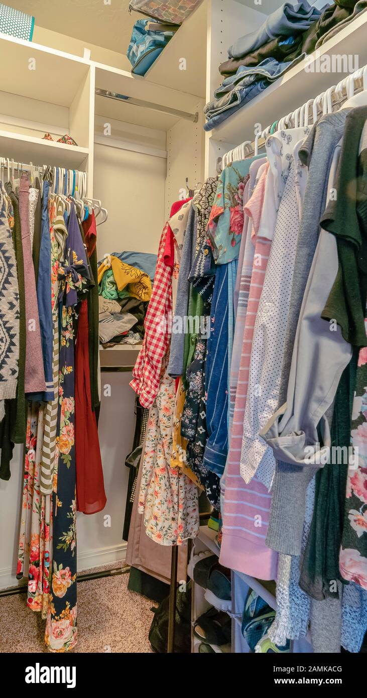 Vertical Clothing hanging up in a walk-in closet Stock Photo - Alamy