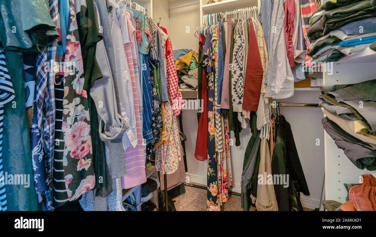 Panorama frame Clothing hanging up in a walk-in closet Stock Photo - Alamy