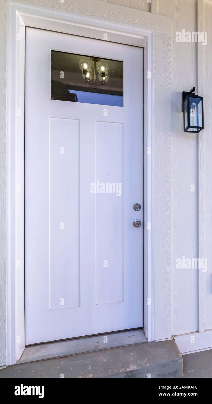 Vertical frame Large square window alongside a white door Stock Photo ...