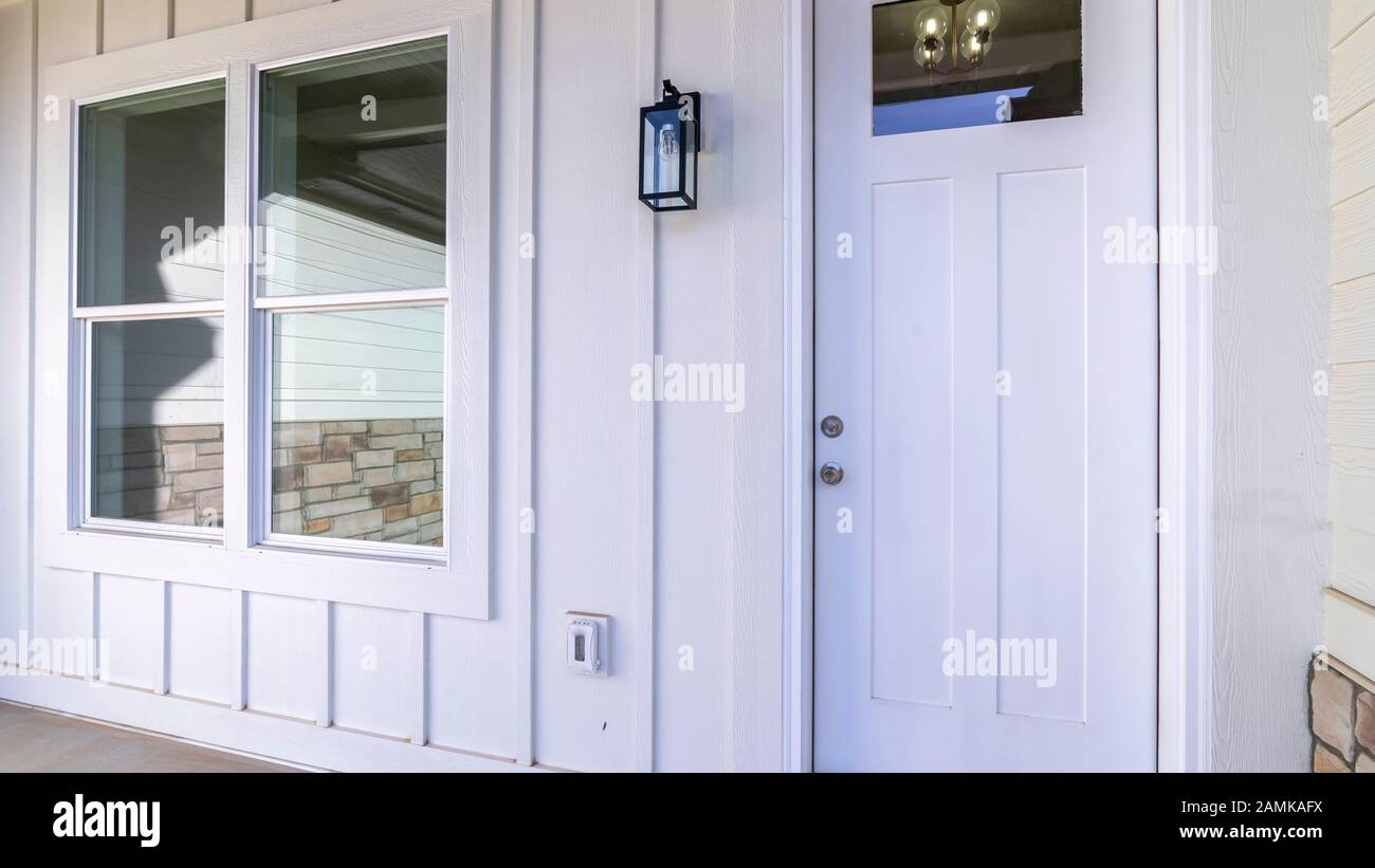 Panorama Large square window alongside a white door Stock Photo - Alamy