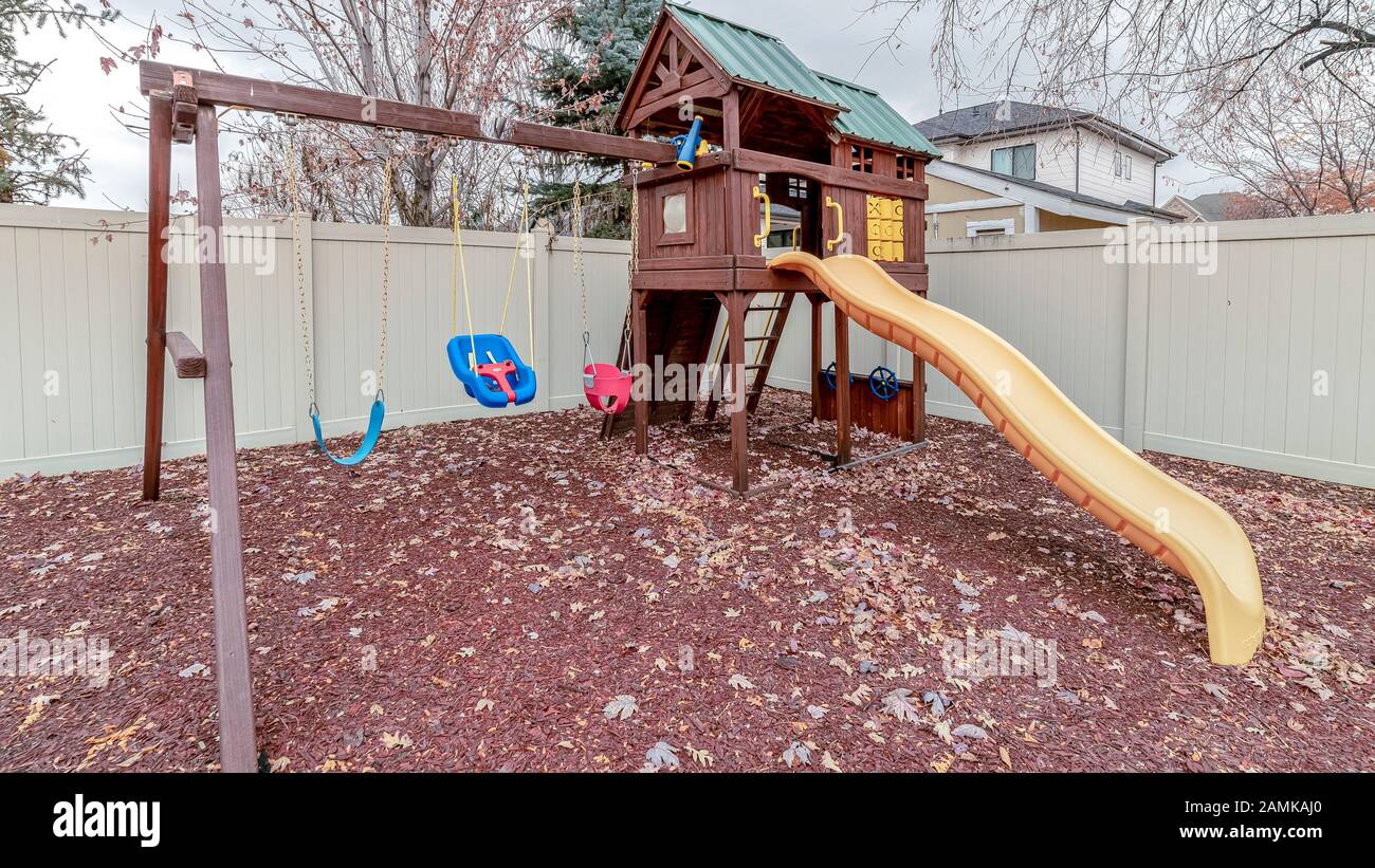 Panorama Kids playground with slide and wooden elevated hut Stock Photo ...