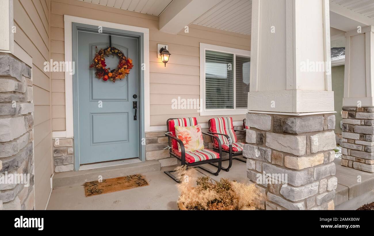 Panorama Potted plants on a covered porch with red chairs Stock Photo ...