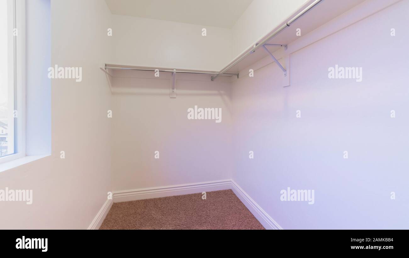Panorama frame Interior of empty walk-in wardrobe with rails Stock ...