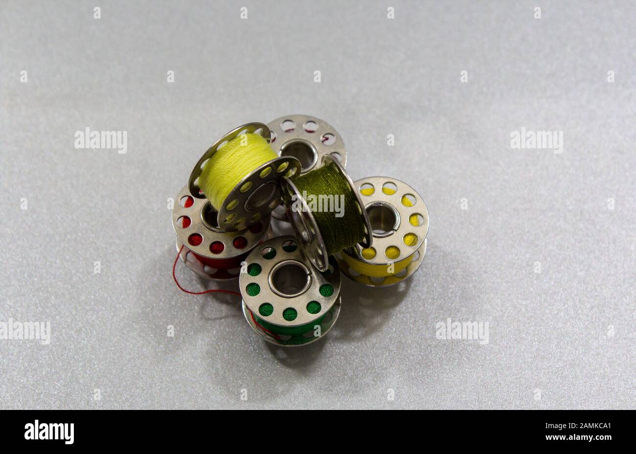 Yarn coils of a sewing machine with different yarn colours Stock Photo ...