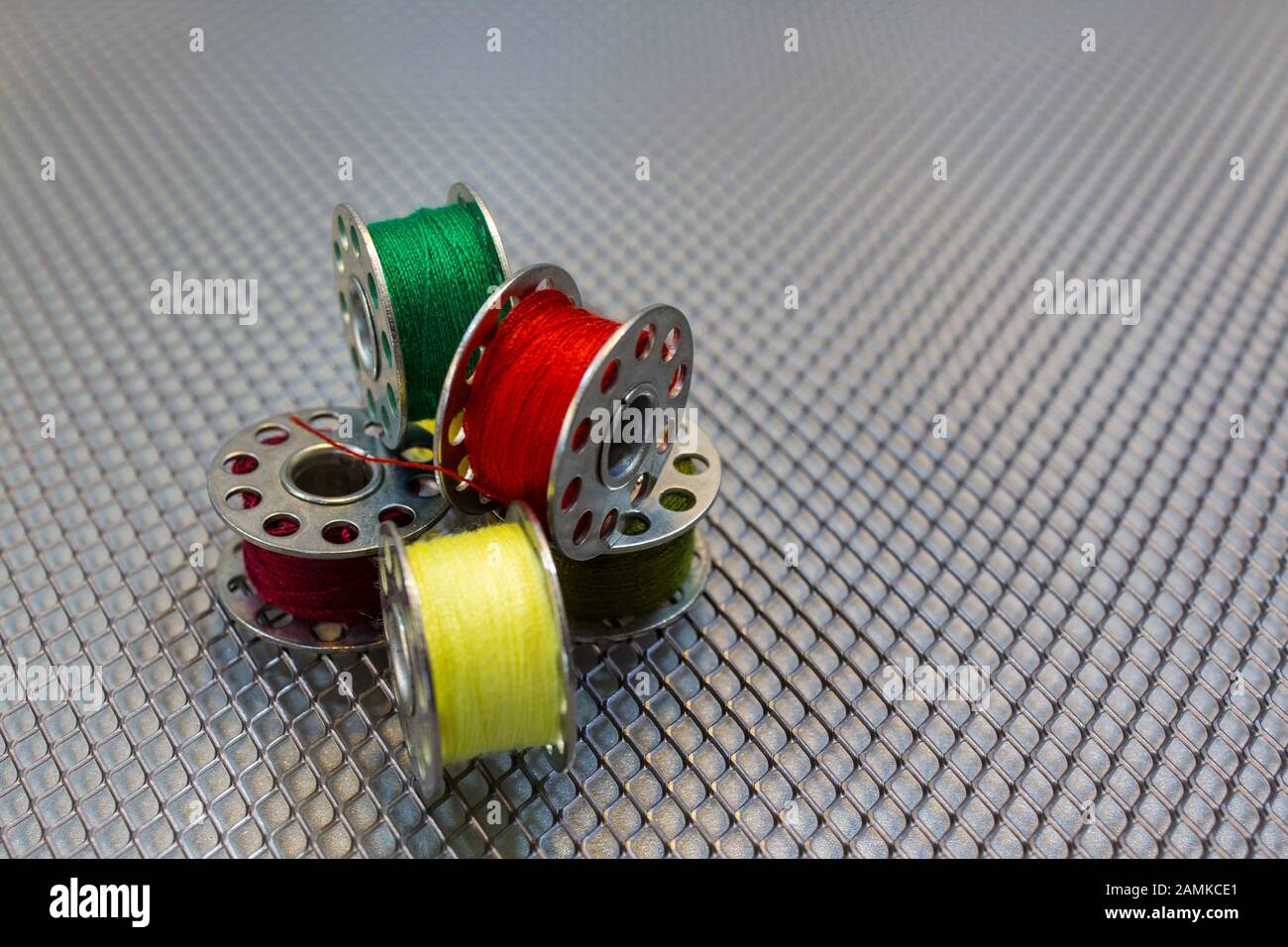Yarn coils of a sewing machine with different yarn colours Stock Photo ...