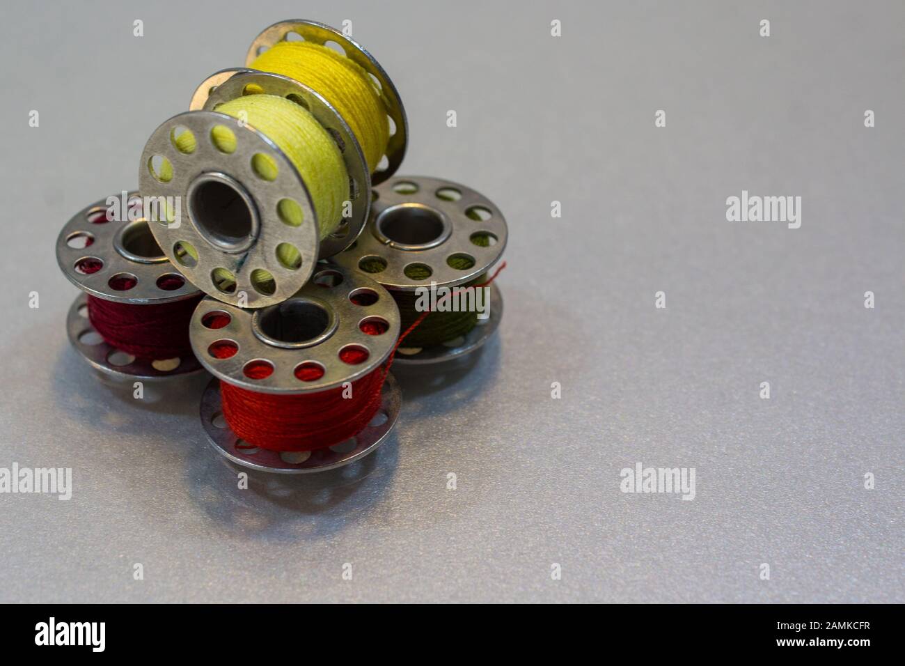 Yarn coils of a sewing machine with different yarn colours Stock Photo ...